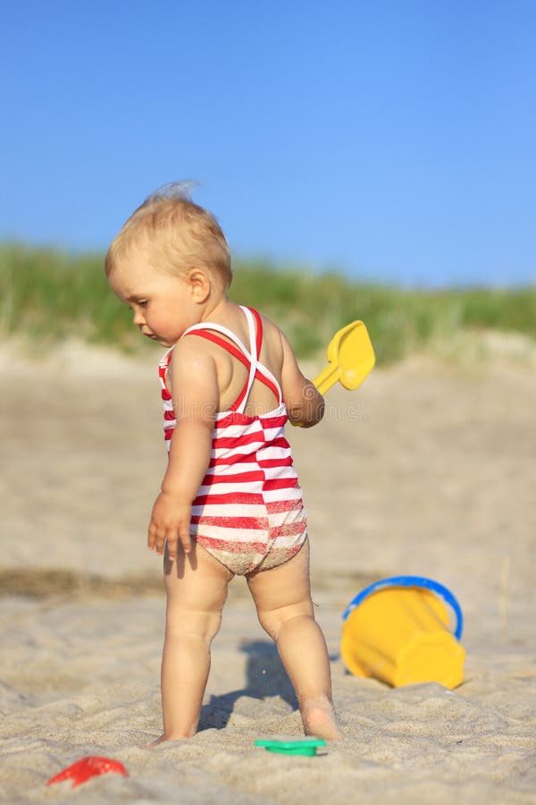 Baby girl on a beach stock image. Image of swimsuit, baby - 17824925