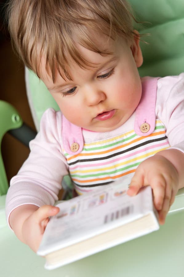 Baby girl with book stock image. Image of cute, portrait - 18254079