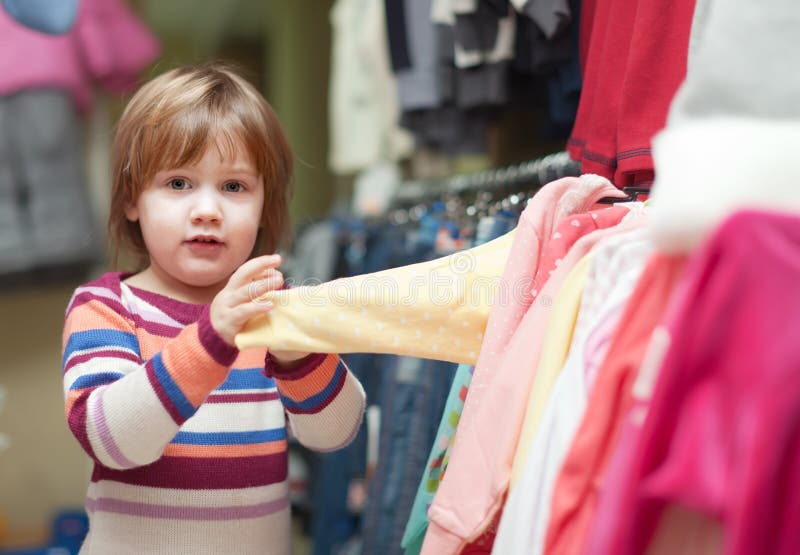 Baby girl chooses clothes stock image. Image of fashionable - 29116387
