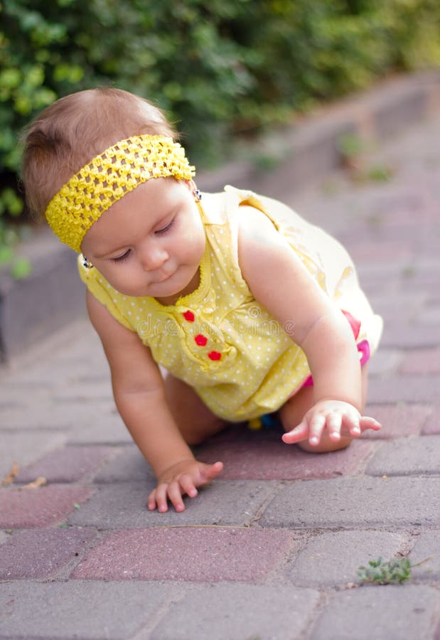 Baby girl crawling stock image. Image of serious, park - 33152499
