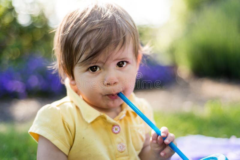 Baby girl drinking water stock image. Image of suck, grass - 31340435