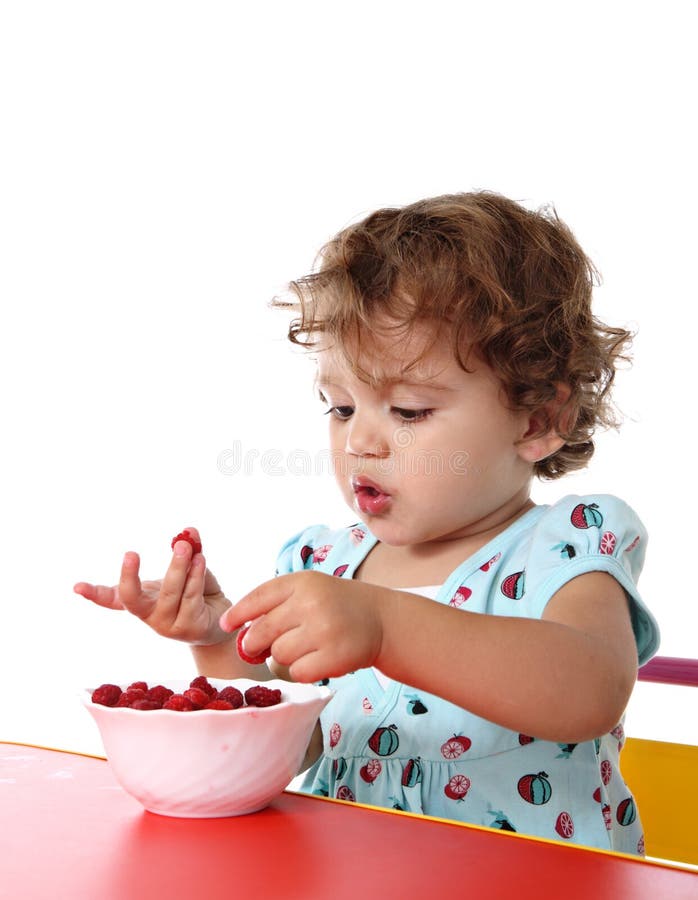 Baby girl eating raspberry stock image. Image of curly - 15281631