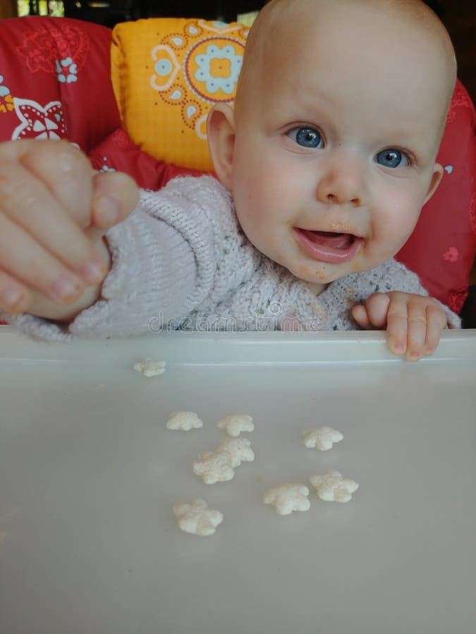 Baby girl with first foods stock image. Image of organ - 240085505