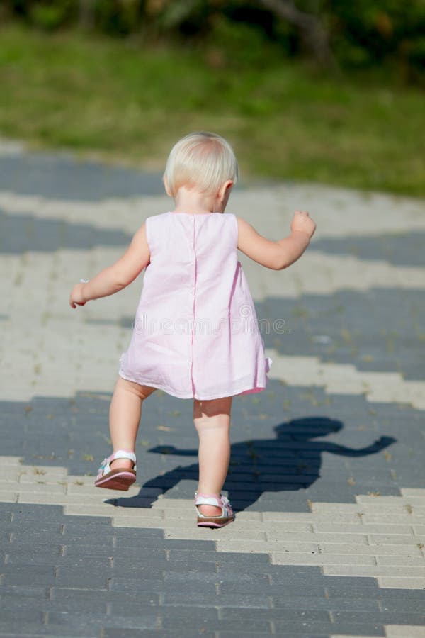 Baby Girl Having Her First Steps Stock Photo - Image of sunny, girl ...