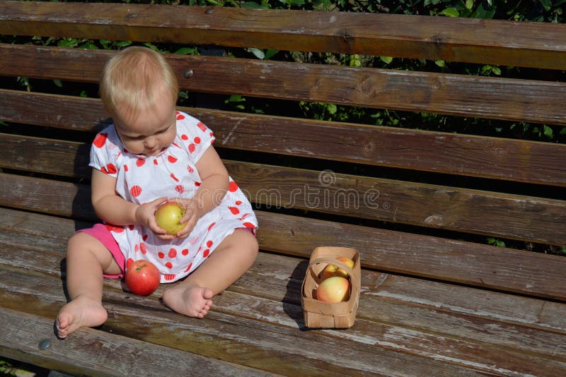 The Baby Girl Investigating an Apple Stock Photo - Image of barefoot ...