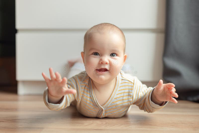 Baby Girl Learning To Crawl, Smiling at the Camera, Underfloor Heating ...