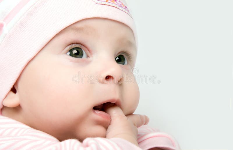 Baby Girl Looks Unconcerned Stock Photo - Image of oblivious, addiction ...