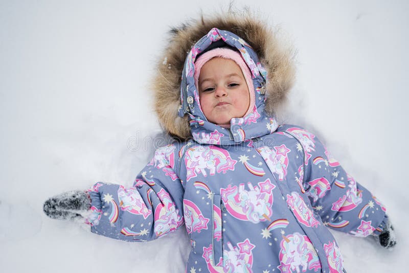 Baby Girl Making Snow Angel while Lying on Snow Stock Image - Image of ...