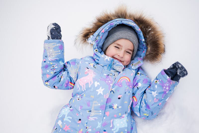 Baby Girl Making Snow Angel while Lying on Snow Stock Image - Image of ...