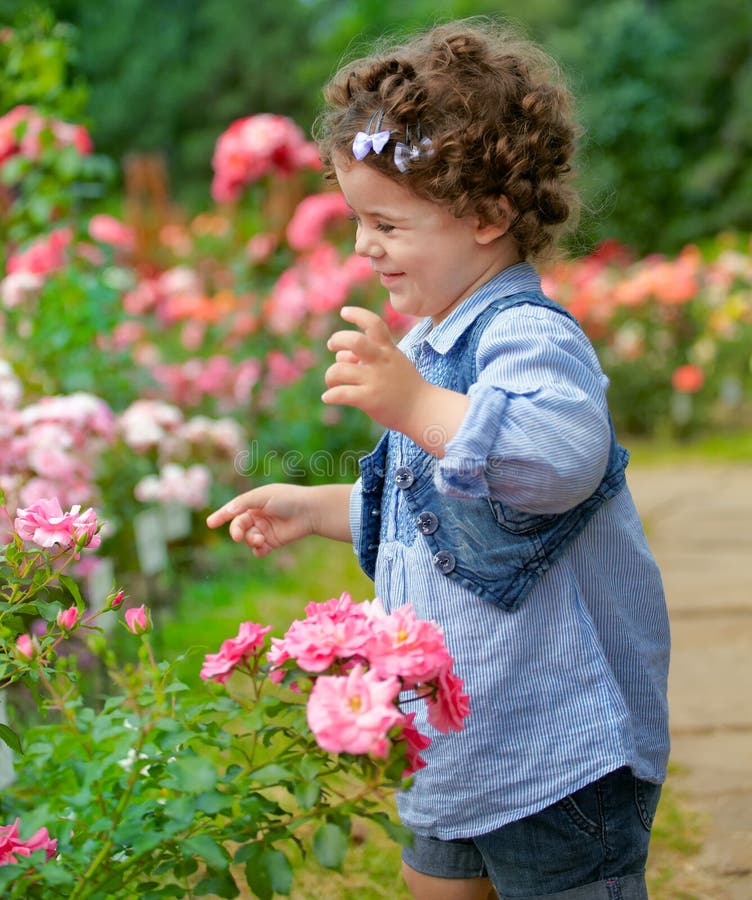 Baby girl in rose garden stock photo. Image of happiness - 28202150