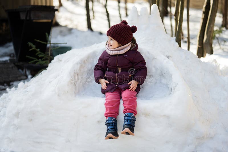 Baby Girl Sits on a Makeshift Throne Made of Snow Stock Photo - Image ...