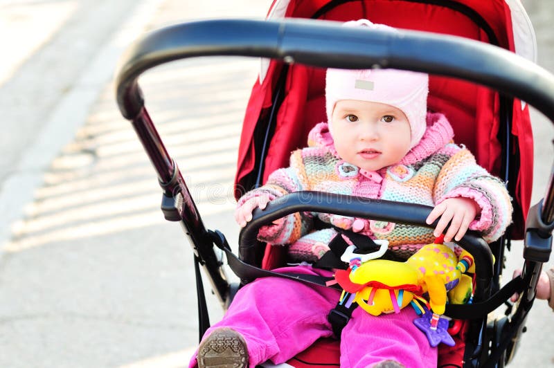 Baby girl in the stroller stock photo. Image of childhood - 65194794