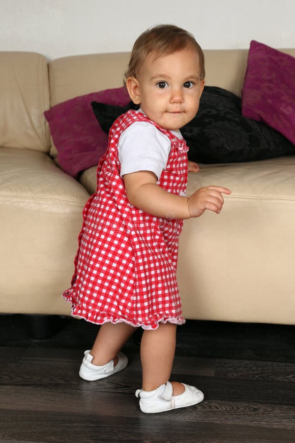 Baby girl tries to walk stock image. Image of looking - 33626643