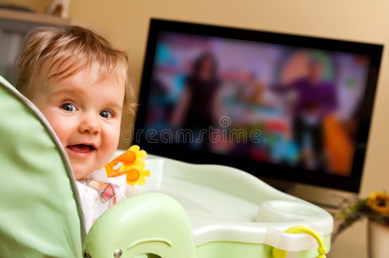 Baby girl watching tv stock image. Image of cheerful - 17019703