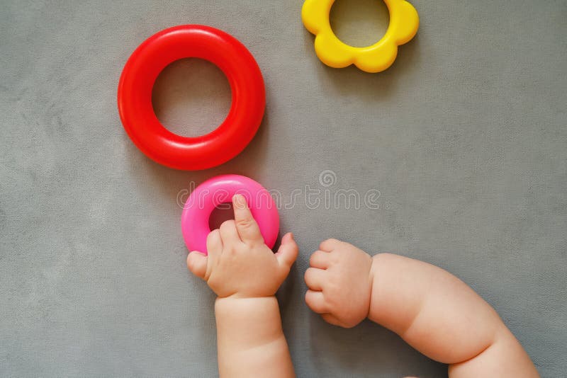 Baby Hand Playing with Plastic Toys. Developing Toys, Early Baby ...
