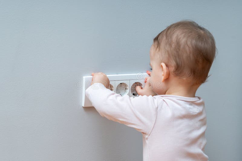 Baby touching power socket stock photo. Image of point - 6121392