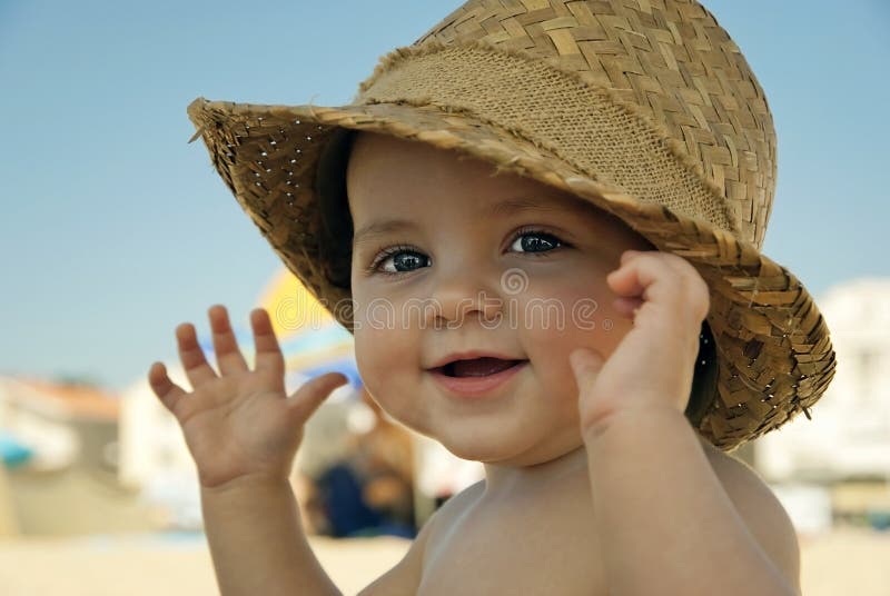 Baby with hat on the beach stock image. Image of face - 27221299