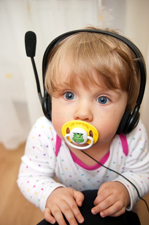 Baby with headset pacifier stock image. Image of listening - 19549563