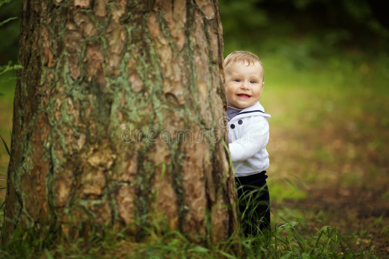 Baby Hiding Behind Tree in Park Stock Image - Image of outdoor, person ...