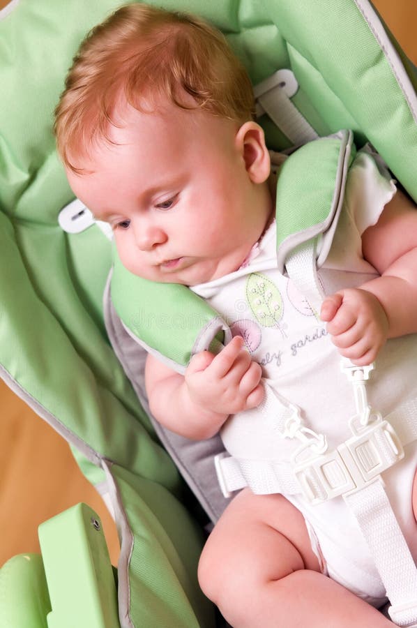 Baby in high feeding chair stock image. Image of straps - 15676221