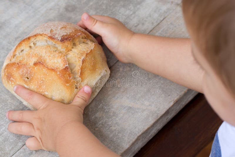 Baby holding fresh bread stock image. Image of person - 61510607