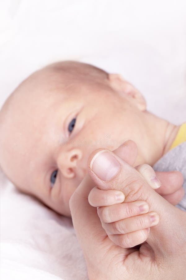 Baby holding mothers thumb stock image. Image of home - 22152907
