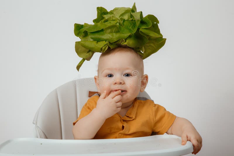 Baby Holding Salad. Fun Hat with Salad. Child Little Boy Eats Vegetable ...