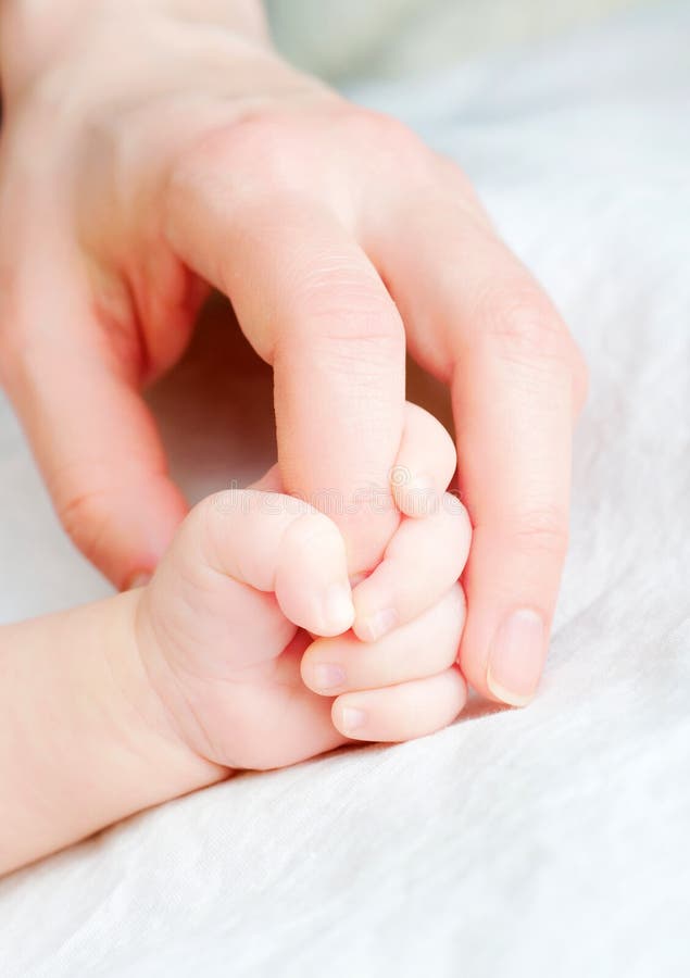 Baby holds mother s finger stock photo. Image of infancy - 30333436