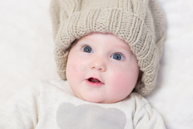 Baby in a Huge Knitted Hat Looking Surprised Stock Image - Image of ...