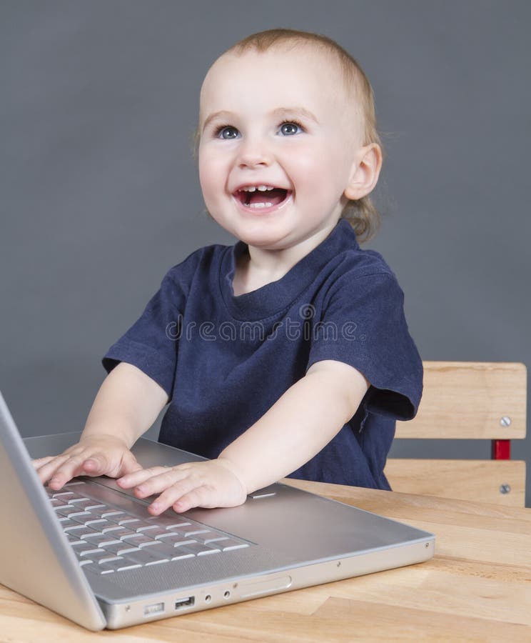 Baby with Laptop Computer in Grey Background Stock Image - Image of ...