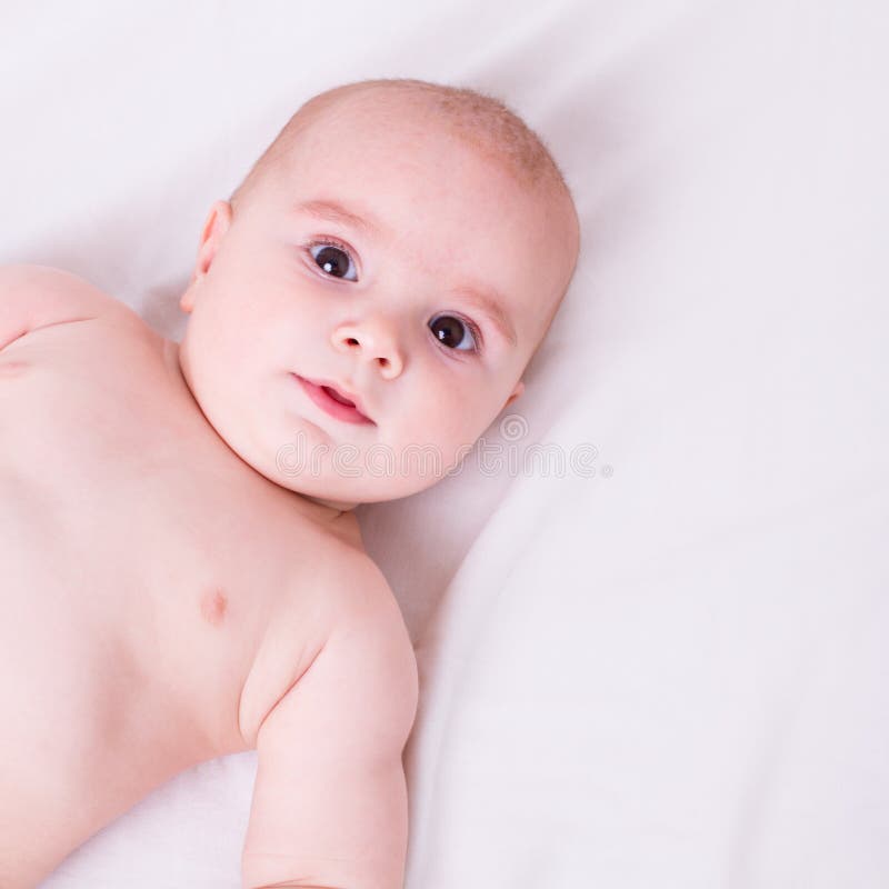 Baby Laying on White Sheets in Bed Stock Photo - Image of bedtime ...