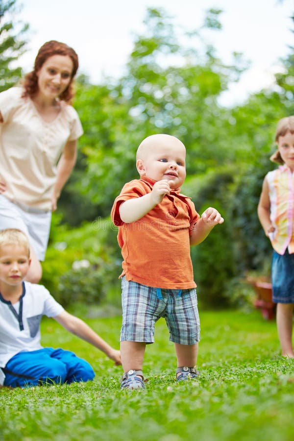 Baby Learning First Steps in Garden Stock Photo - Image of pride ...