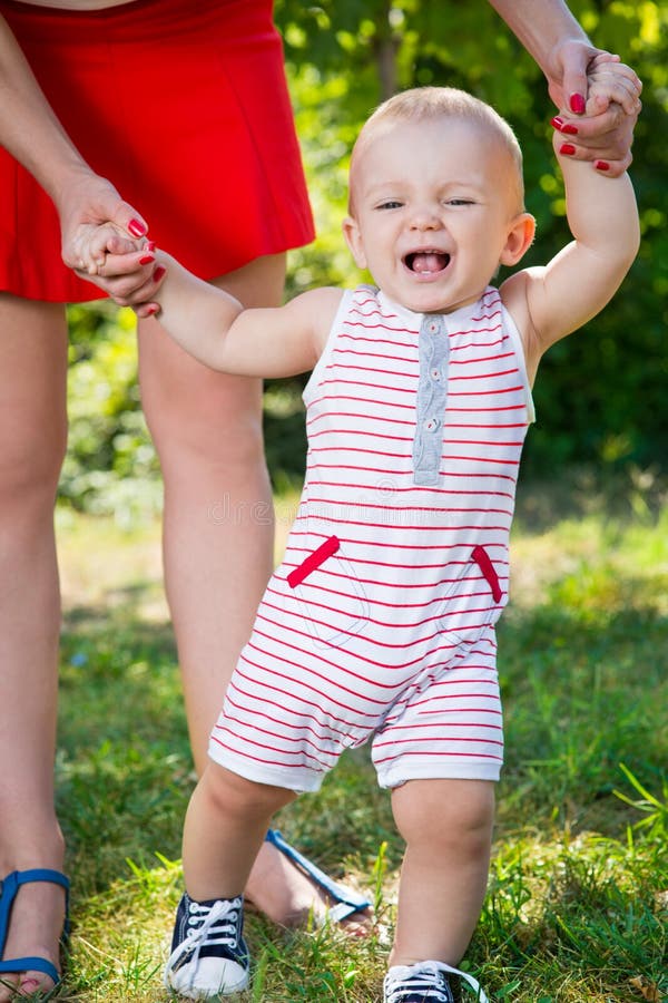 Baby learning to walk stock image. Image of baby, grass - 77157127