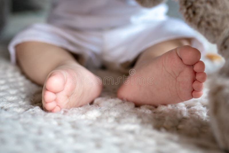 Baby Legs of a Child Lying on the Bed Stock Photo - Image of caucasian ...