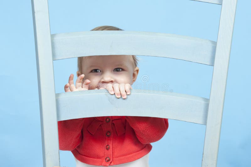 Baby Looking from Behind a Chair Stock Image - Image of caucasian ...