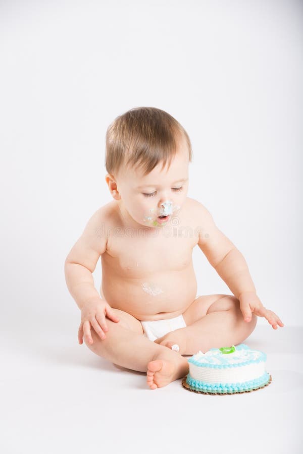 Baby Looking Down at Cake with Face Full of Icing Stock Photo - Image ...