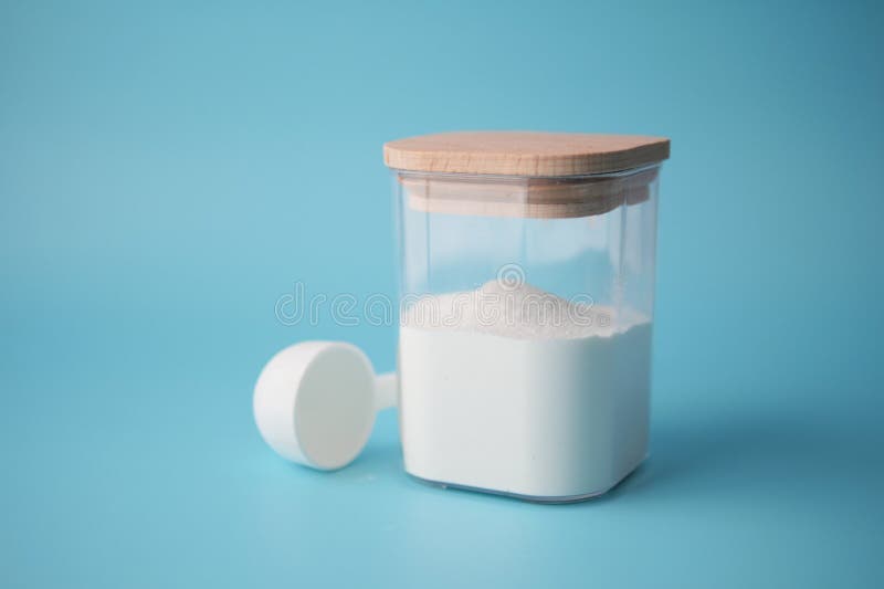 Baby Milk Powder in Container with a Spoon on Blue Background. Stock ...