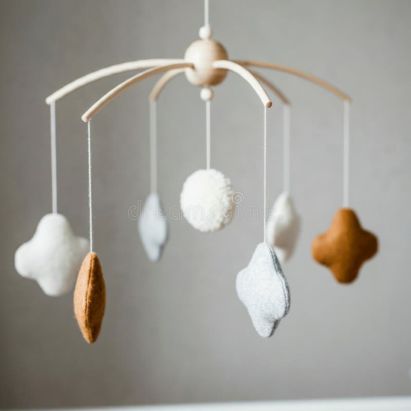 A Baby Mobile Features a Central Wooden Structure from Which Multiple ...