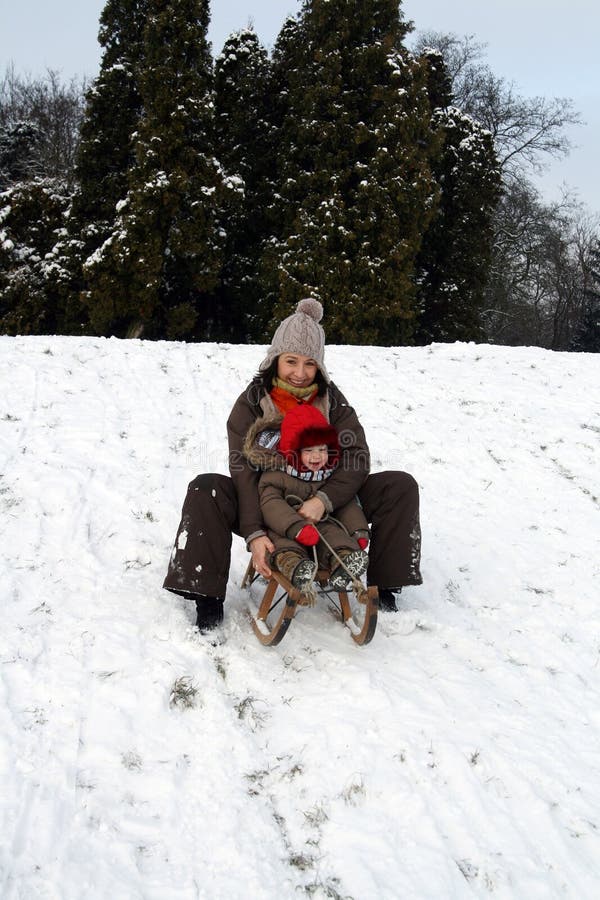 Baby and mom sledding stock photo. Image of riding, seasons - 12385514