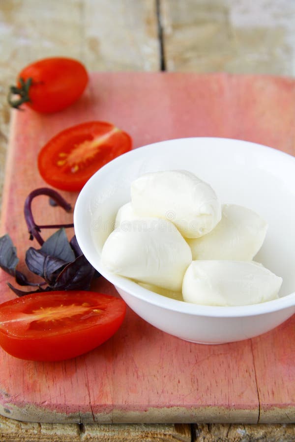 Baby mozzarella and tomato stock photo. Image of basil - 21421102