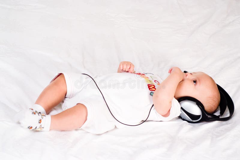 Baby music listening stock image. Image of lying, tiny - 20958811