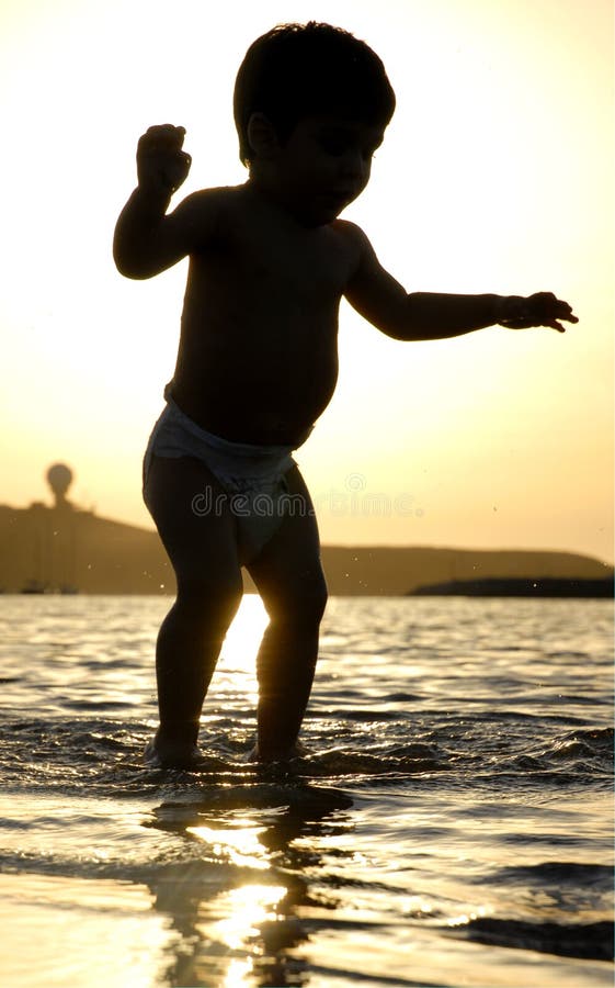 Baby in the Ocean stock image. Image of ocean, beach - 21484387