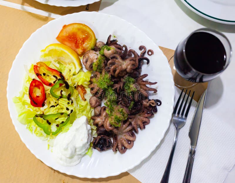 Baby octopus with salad stock photo. Image of feeding - 243262760