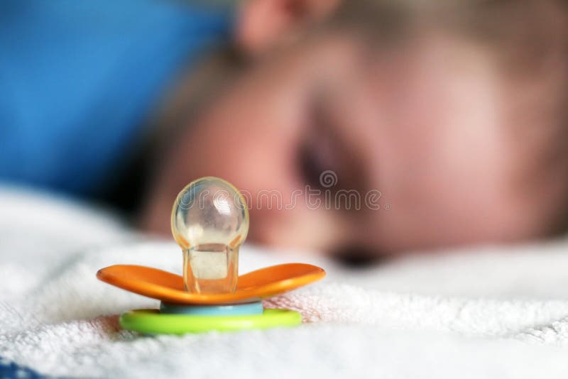 Baby Orange Pacifier and Baby Sleeping Stock Photo - Image of childhood ...