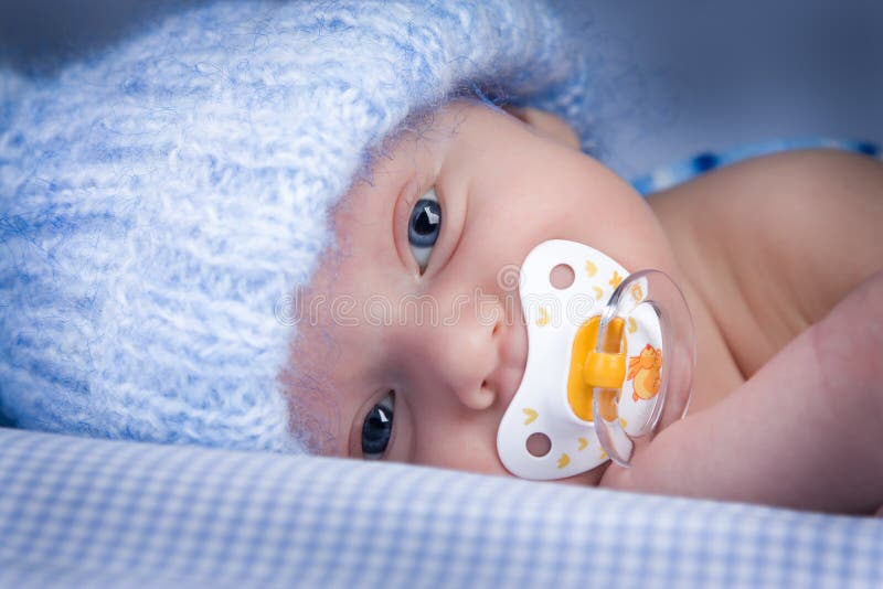 Baby with pacifier stock photo. Image of looking, tired - 13463498