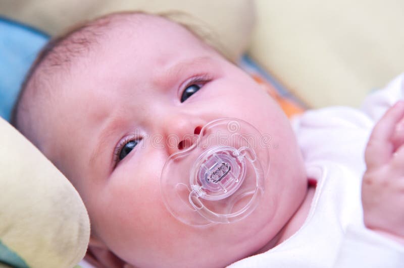 Baby with pacifier stock image. Image of face, lying - 14121399