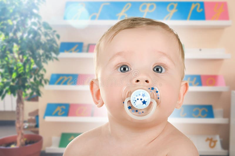 Baby with Pacifier in Bright Classroom Setting Stock Photo - Image of ...