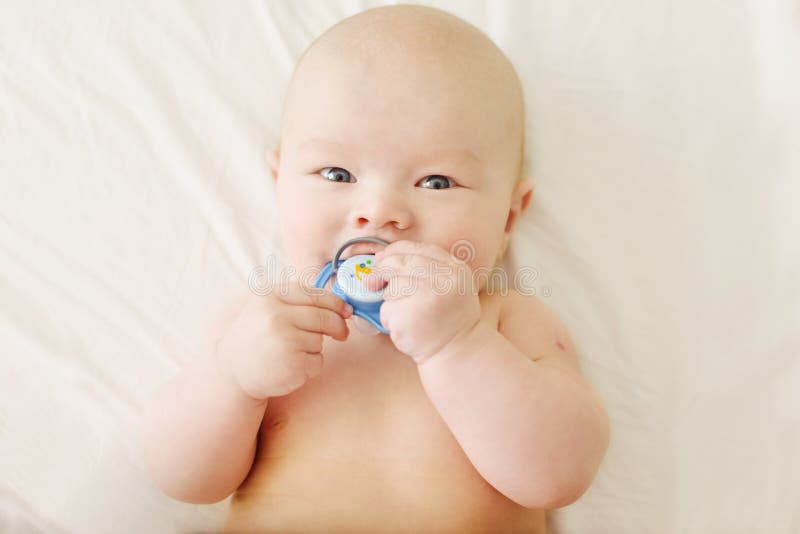 Baby with pacifier stock image. Image of close, born - 127543777