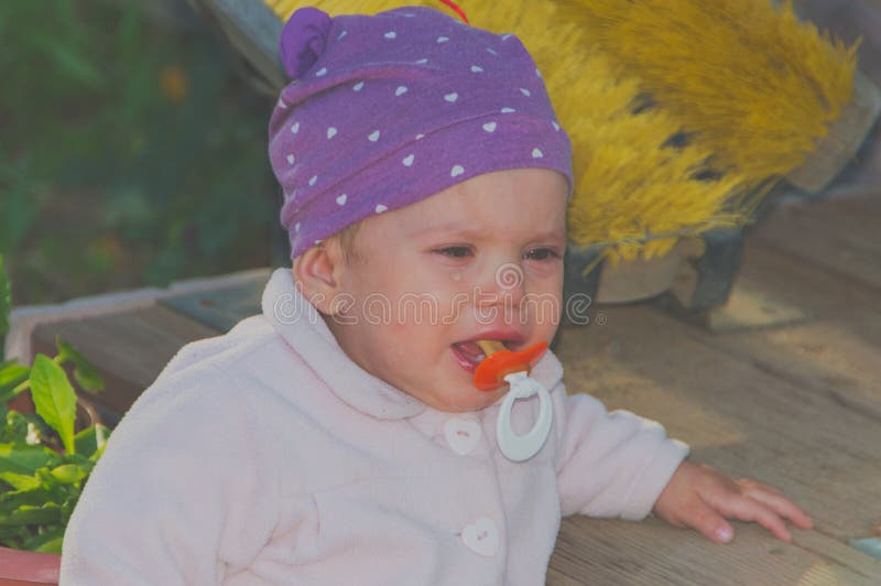 A Baby with a Pacifier in His Mouth Crying Closeup. Stock Photo - Image ...