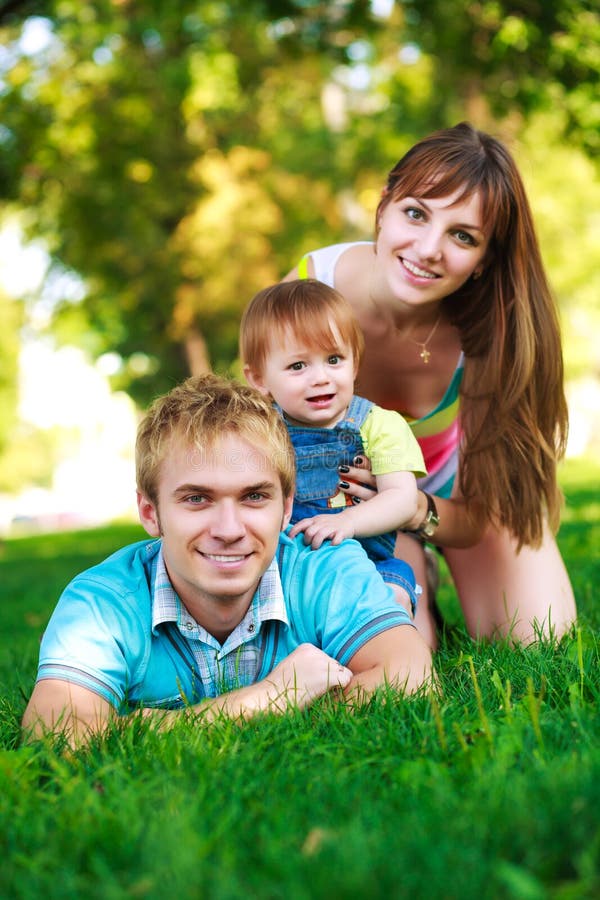 Baby with Parents in a Beautiful Summer Park Stock Photo - Image of ...